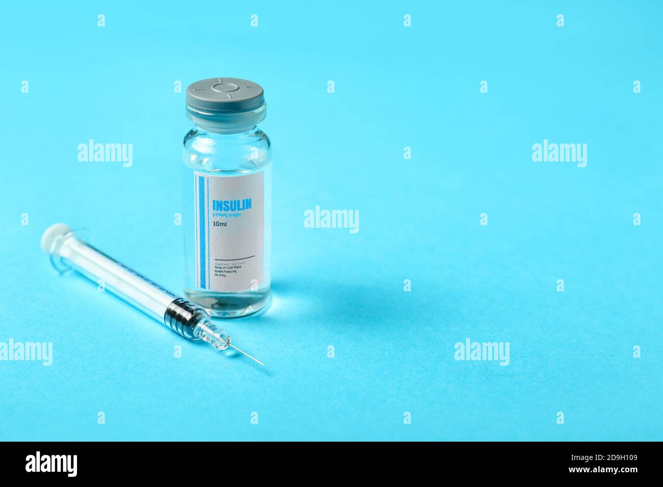 Bottle of insulin with syringe on color background. Diabetes concept ...