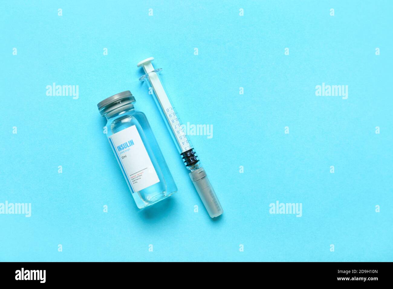 Bottle of insulin with syringe on color background. Diabetes concept ...