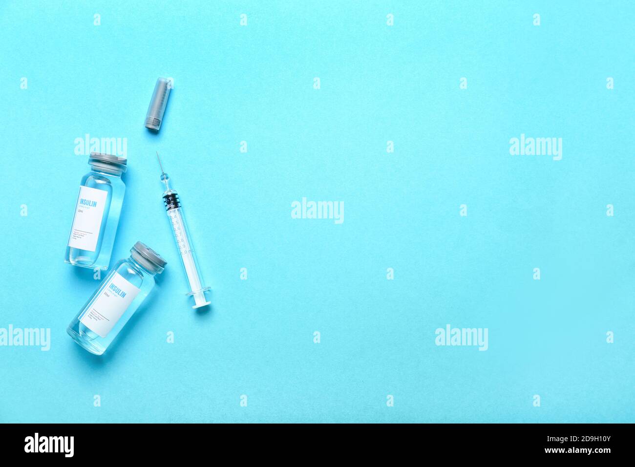 Bottles of insulin with syringe on color background. Diabetes concept ...