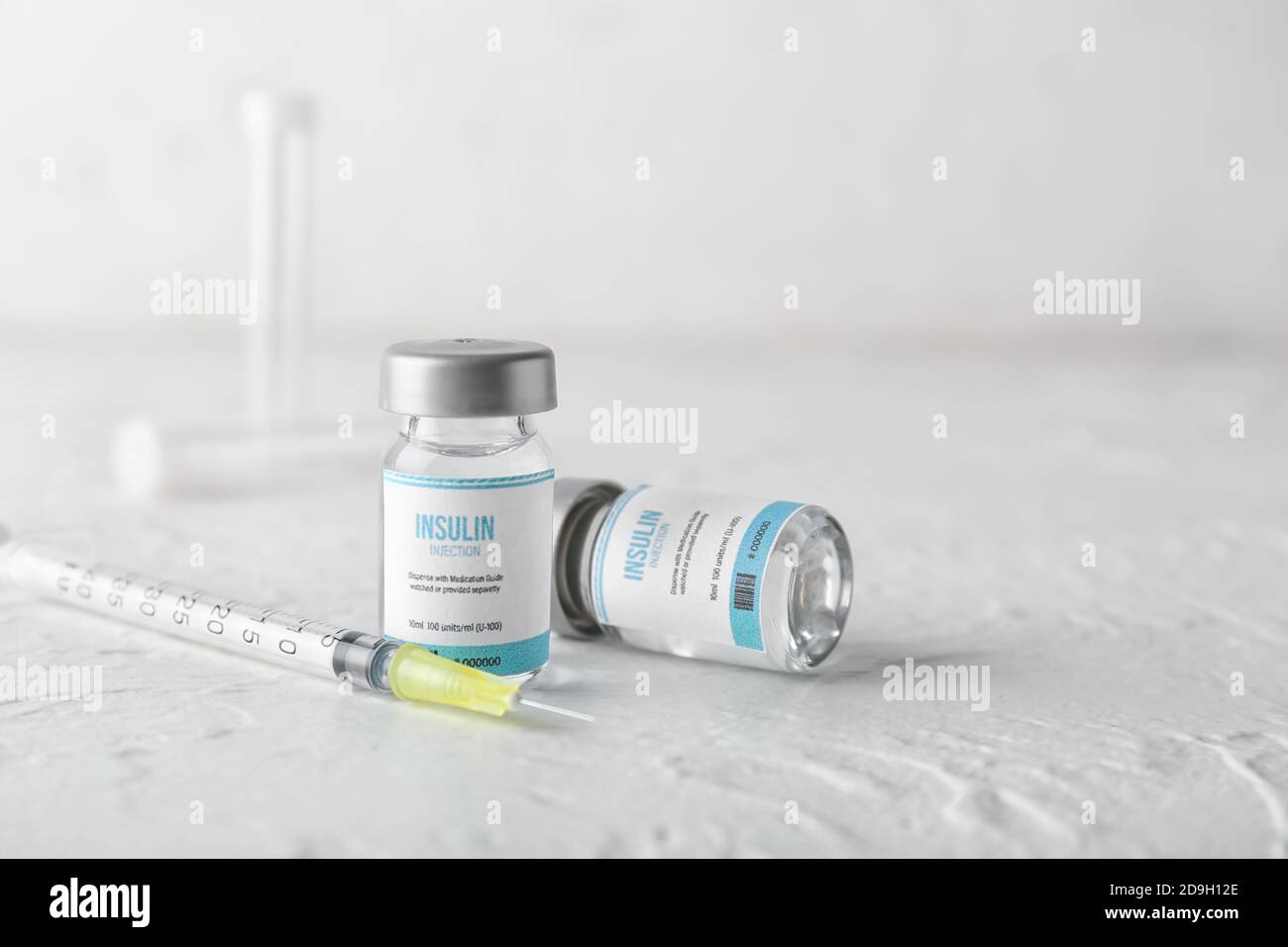 Bottles of insulin with syringe on white background. Diabetes concept ...