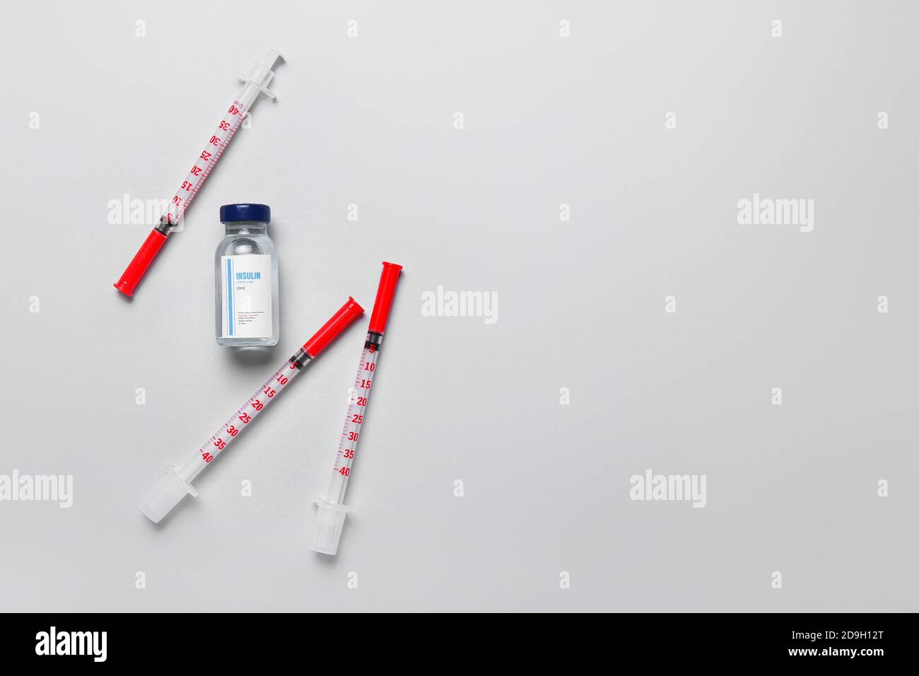 Bottle of insulin with syringes on white background. Diabetes concept ...