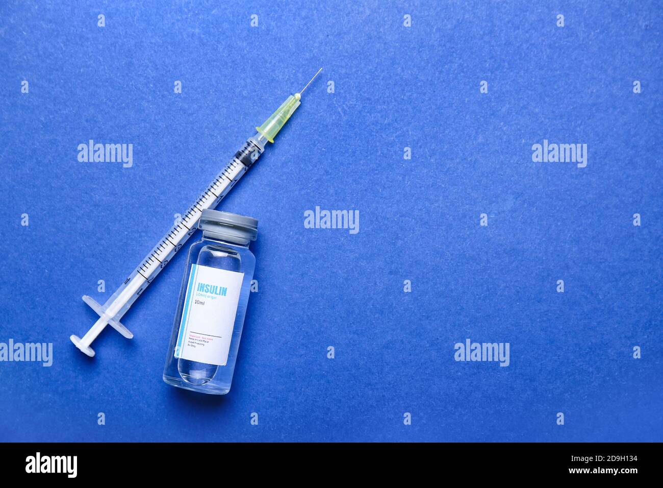 Bottle of insulin with syringe on color background. Diabetes concept ...