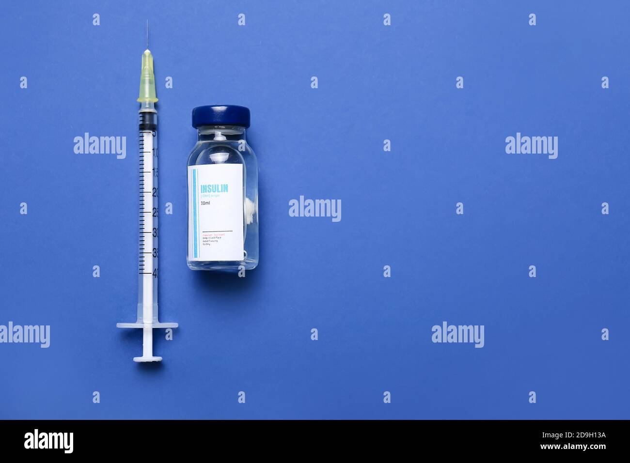 Bottle of insulin with syringe on color background. Diabetes concept ...
