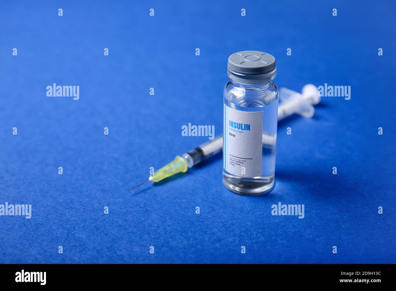 Bottle of insulin with syringe on color background. Diabetes concept ...