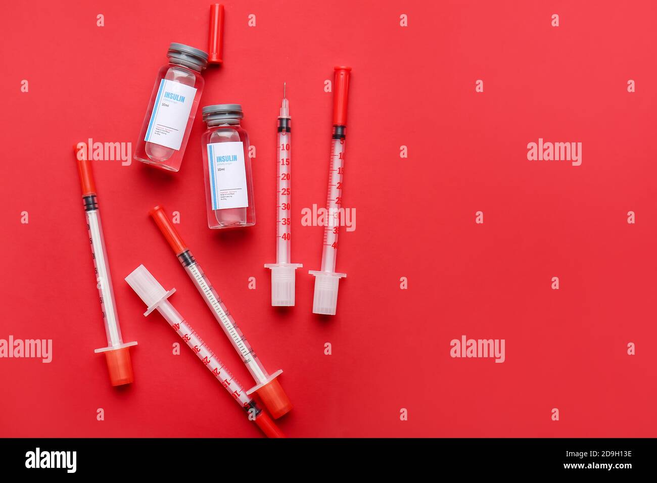 Bottles of insulin with syringes on color background. Diabetes concept ...