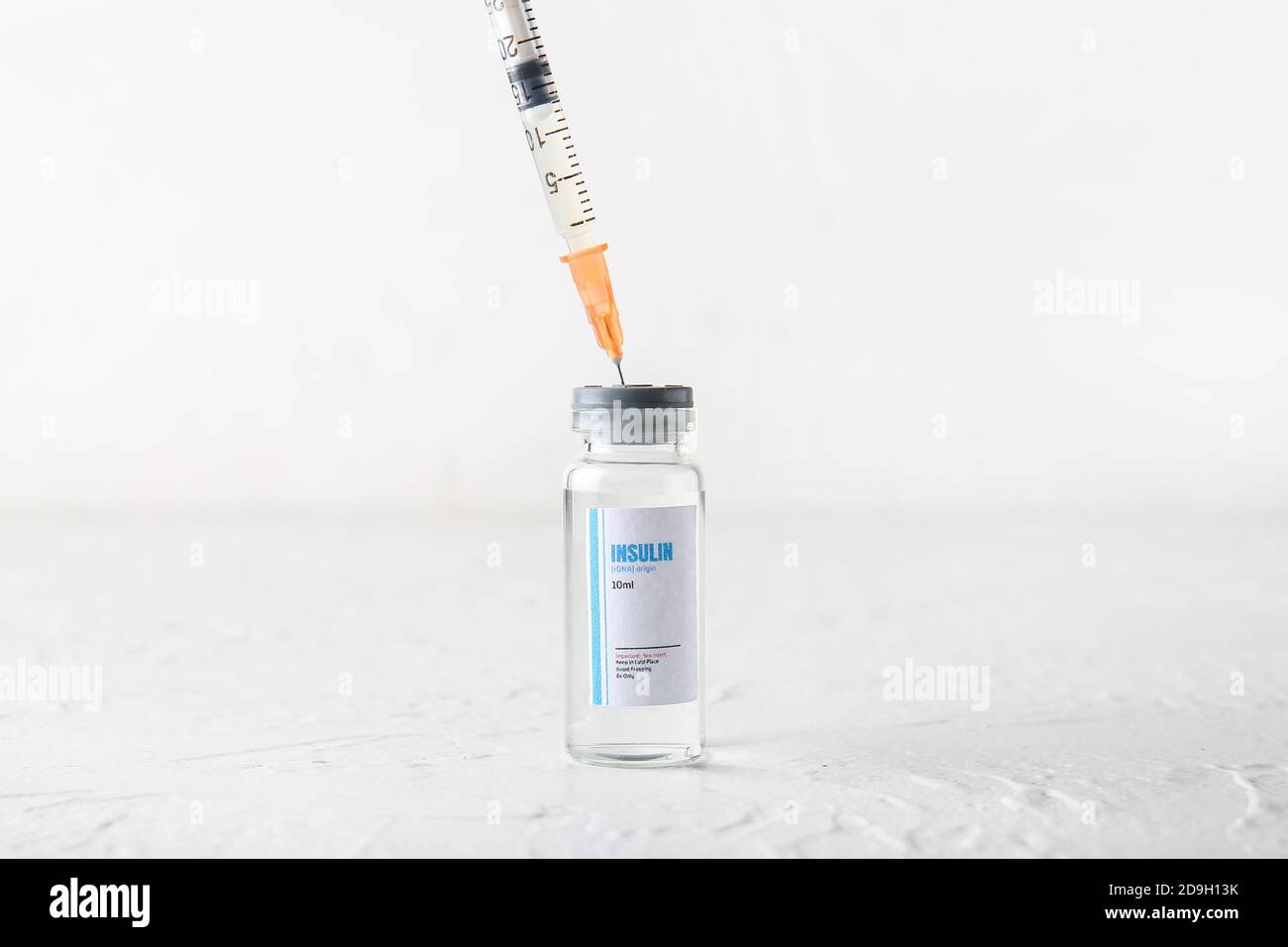 Bottle of insulin with syringe on white background. Diabetes concept ...