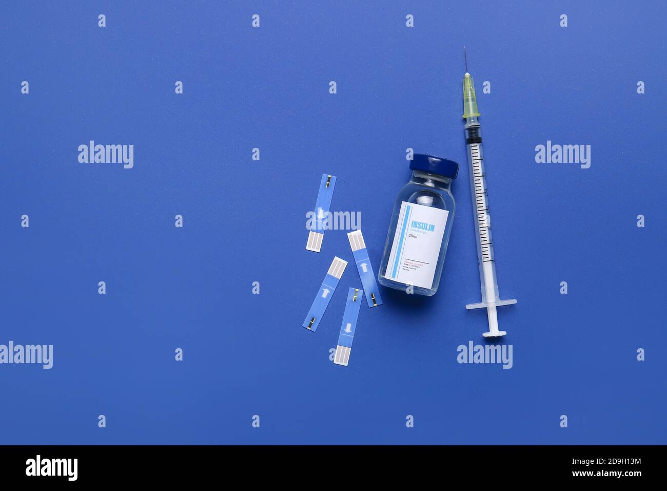 Bottle of insulin with syringe and test strips of glucometer on color ...