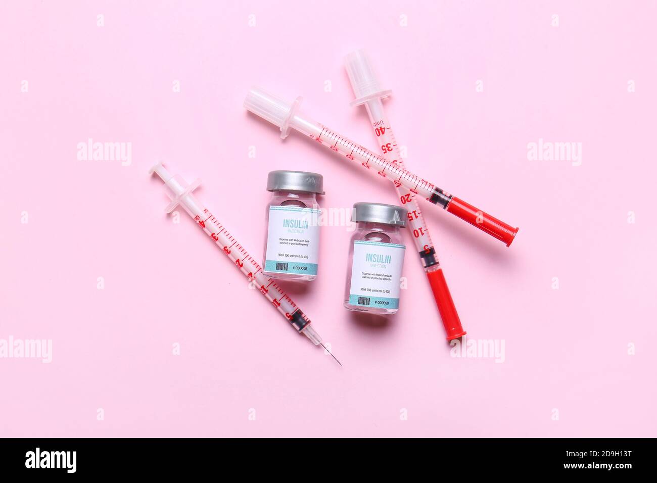 Bottles of insulin with syringes on color background. Diabetes concept ...