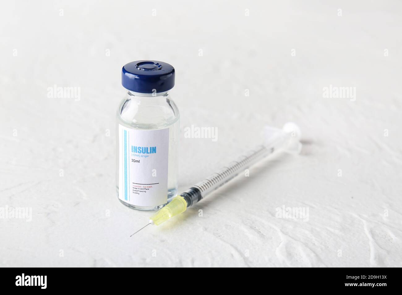 Bottle of insulin with syringe on white background. Diabetes concept ...