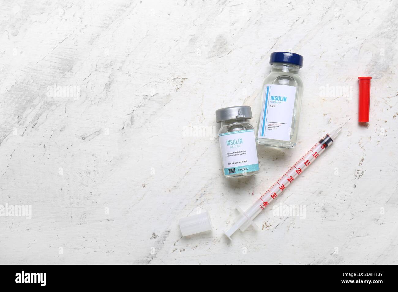 Bottles of insulin with syringe on white background. Diabetes concept ...