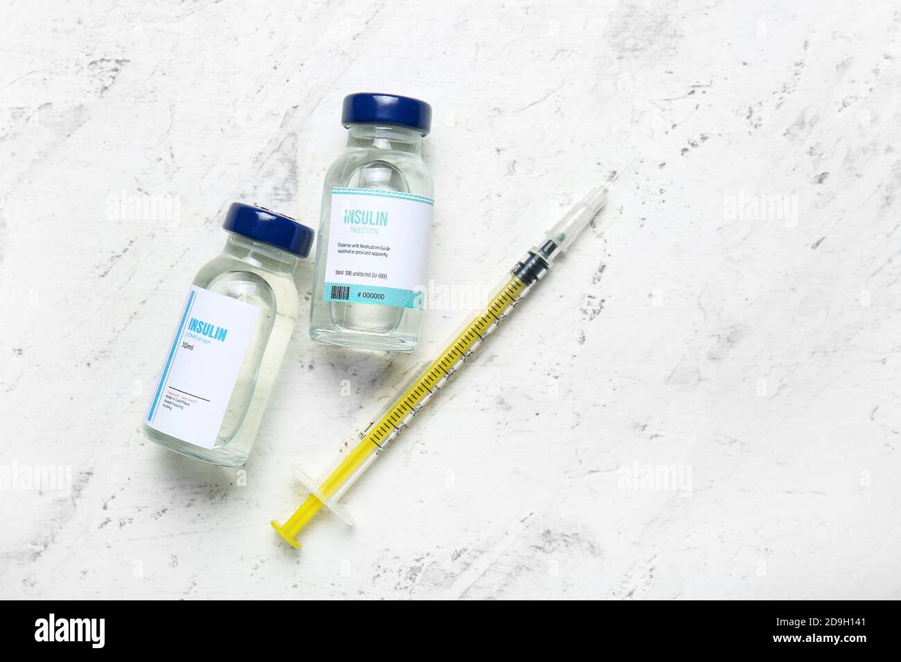 Bottles of insulin with syringe on white background. Diabetes concept ...