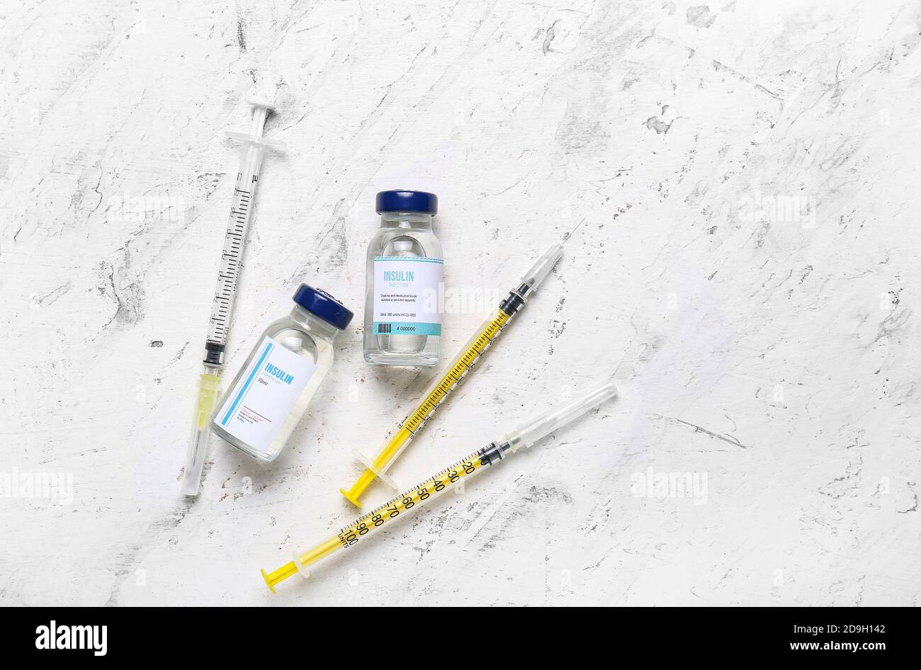 Bottles of insulin with syringes on white background. Diabetes concept ...