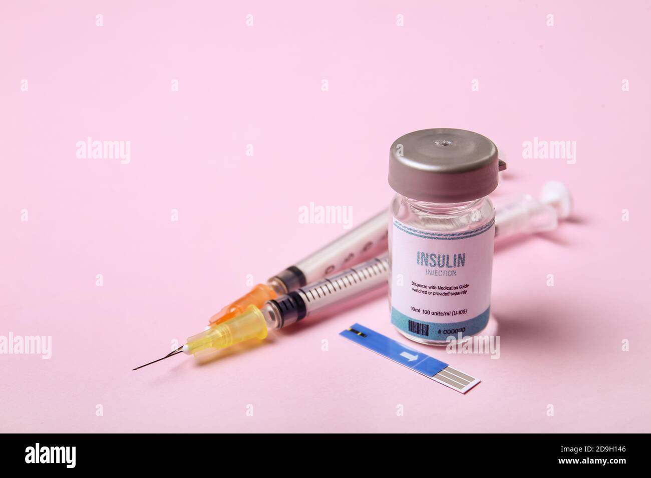 Bottle of insulin with syringes and test strip of glucometer on color ...