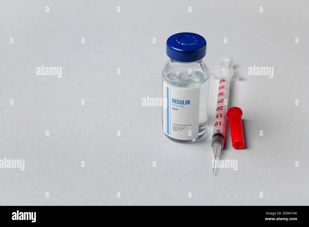 Bottle of insulin with syringe on white background. Diabetes concept ...