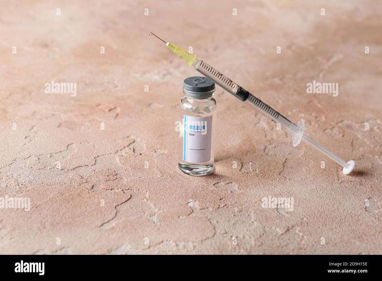 Bottle of insulin with syringe on color background. Diabetes concept ...