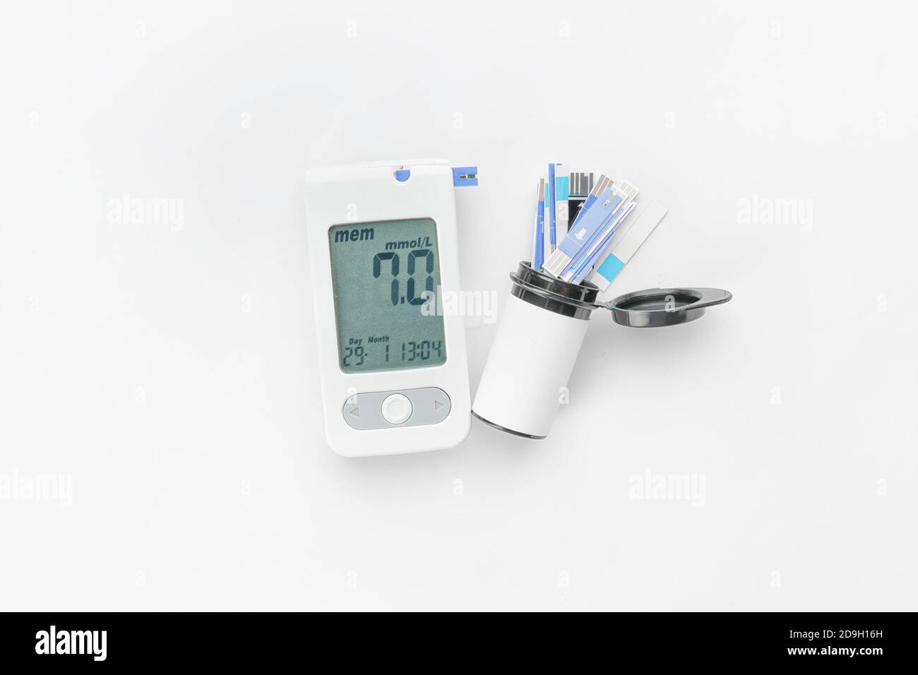 Glucometer and test strips on white background. Diabetes concept Stock ...