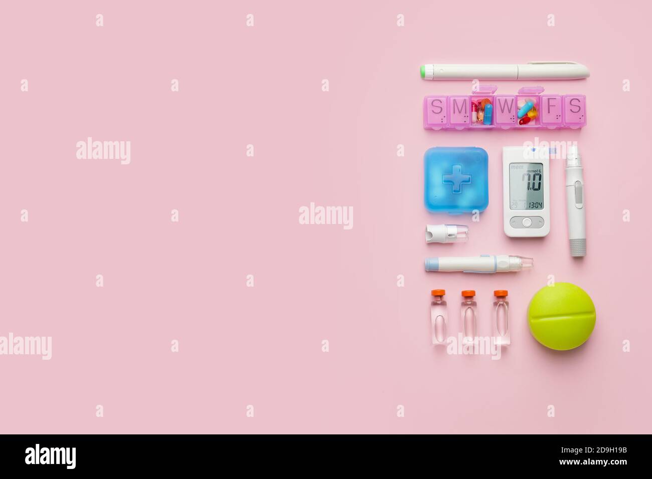 Glucometer with medications and lancet pens on color background ...