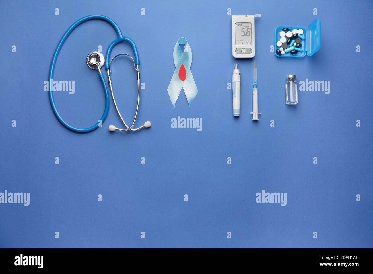 Glucometer with medications, syringe, lancet pen, awareness ribbon and ...