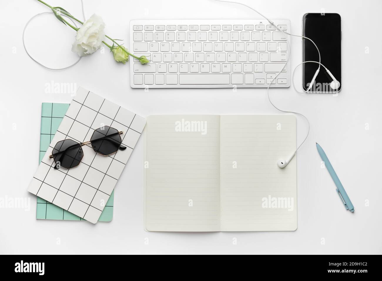 Composition with empty notebook, computer keyboard and stationery on ...