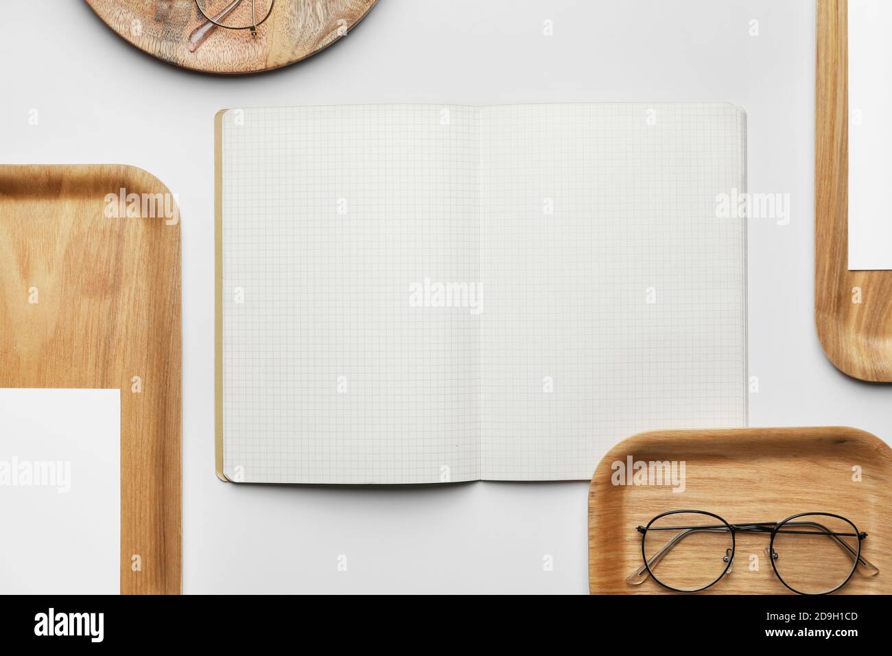 Composition with empty notebook and plates on white background Stock ...