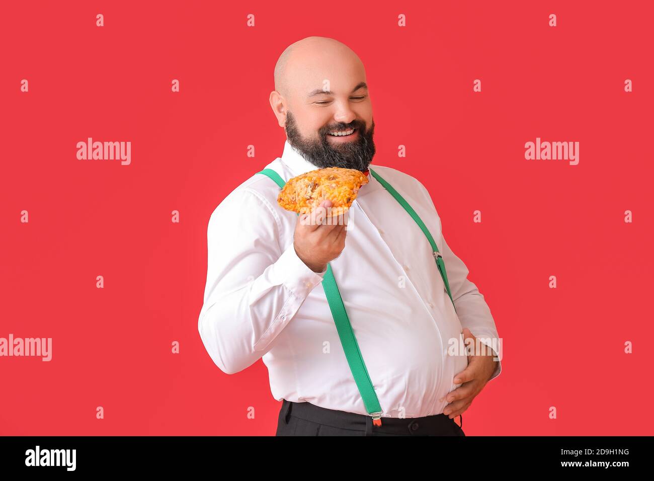 Overweight man with pizza on color background Stock Photo - Alamy