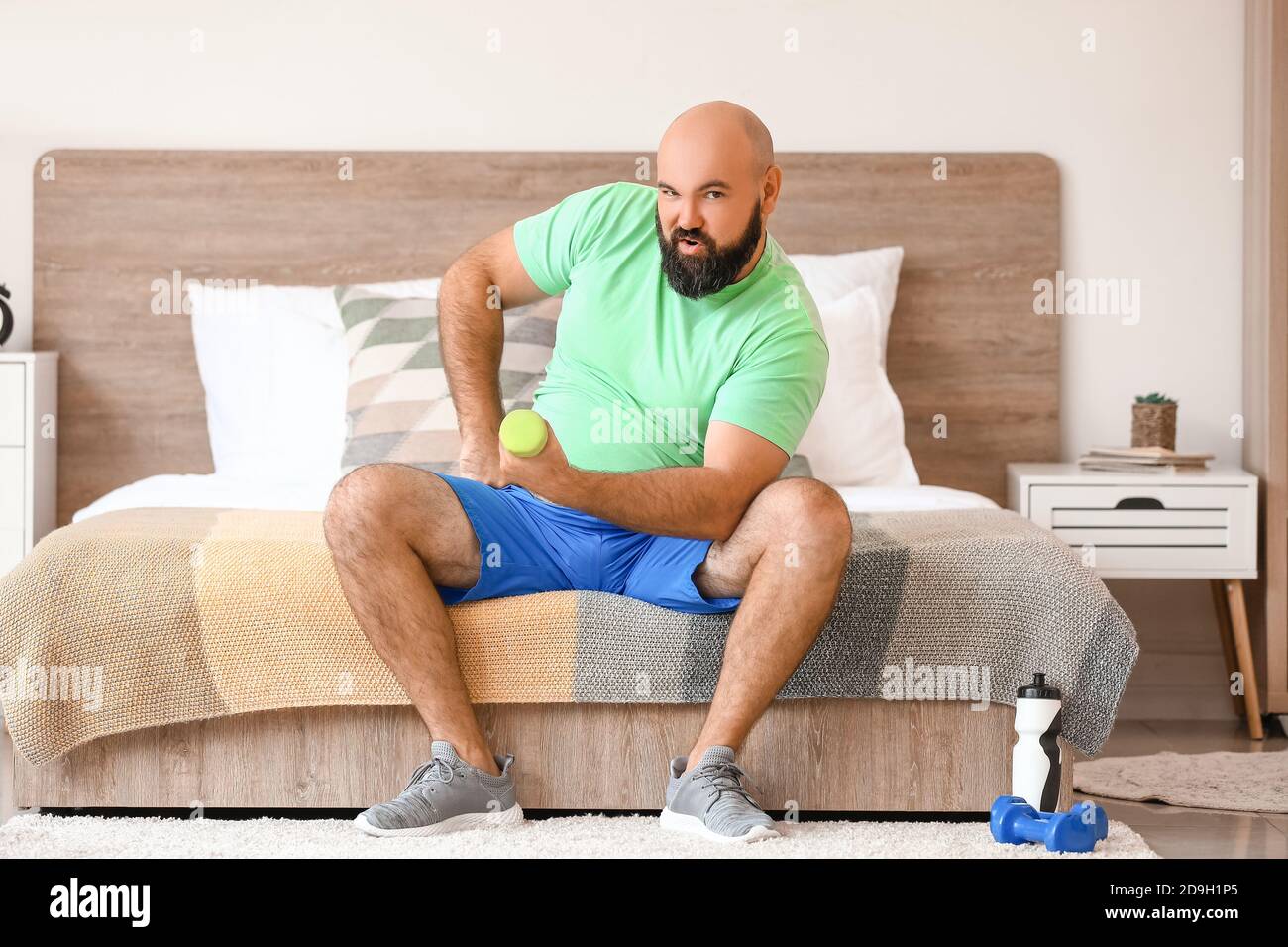 Overweight man training at home. Weight loss concept Stock Photo - Alamy