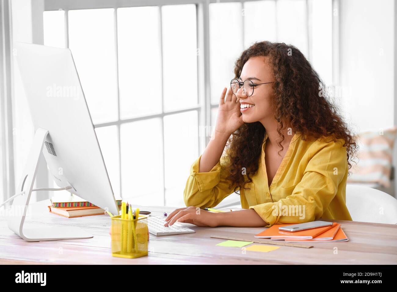 African-American woman working on computer at home Stock Photo - Alamy