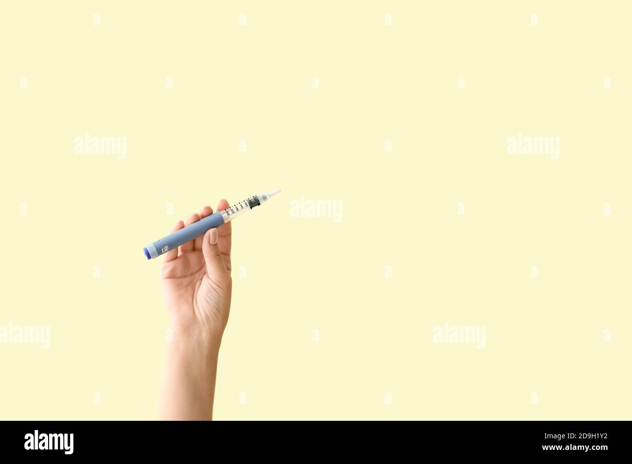 Female hand with syringe for insulin injection on color background ...