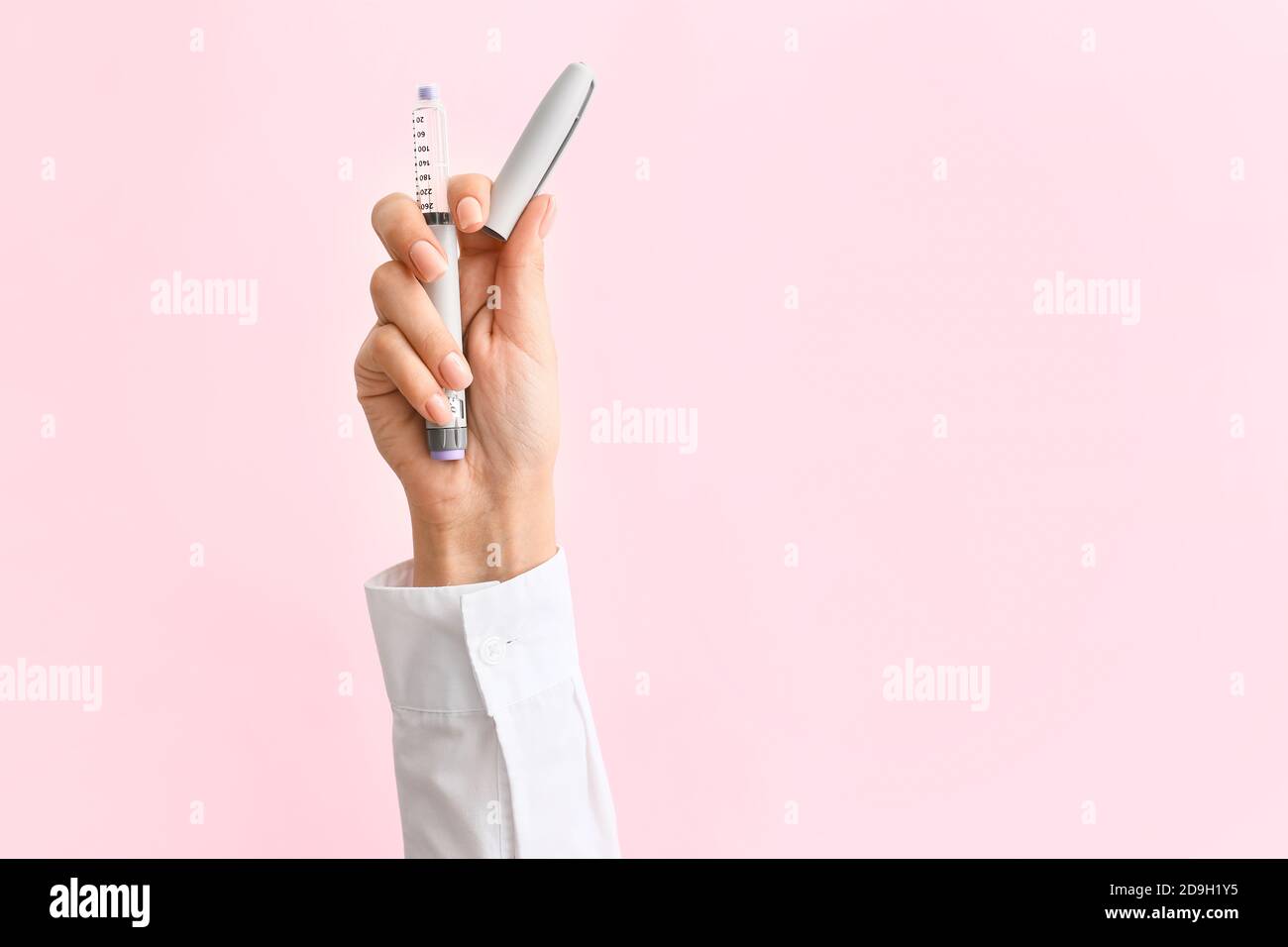 Female hand with syringe for insulin injection on color background ...