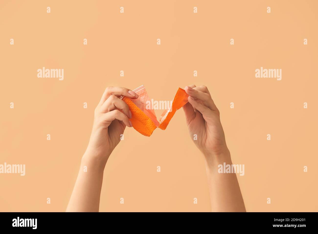 Female hands tearing plastic cup on color background. Ecology concept ...