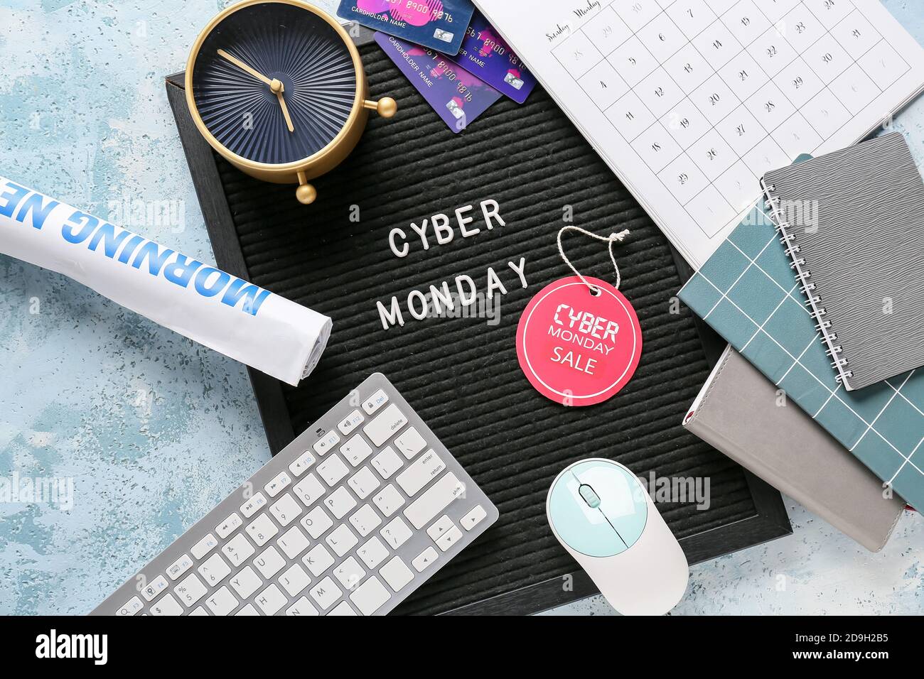 Computer keyboard, alarm clock, credit cards and board with text CYBER ...