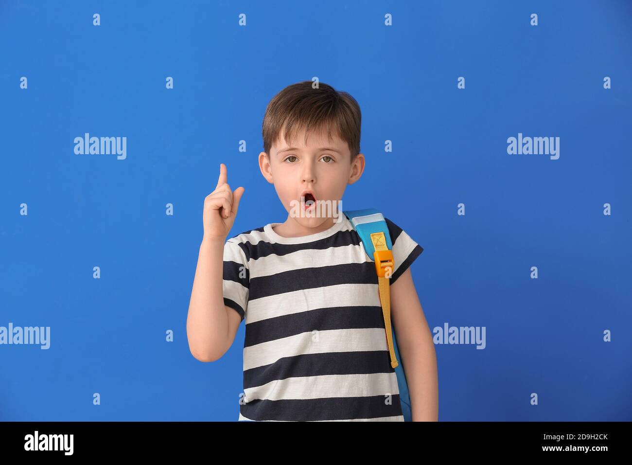 Little schoolboy with raised index finger on color background Stock ...