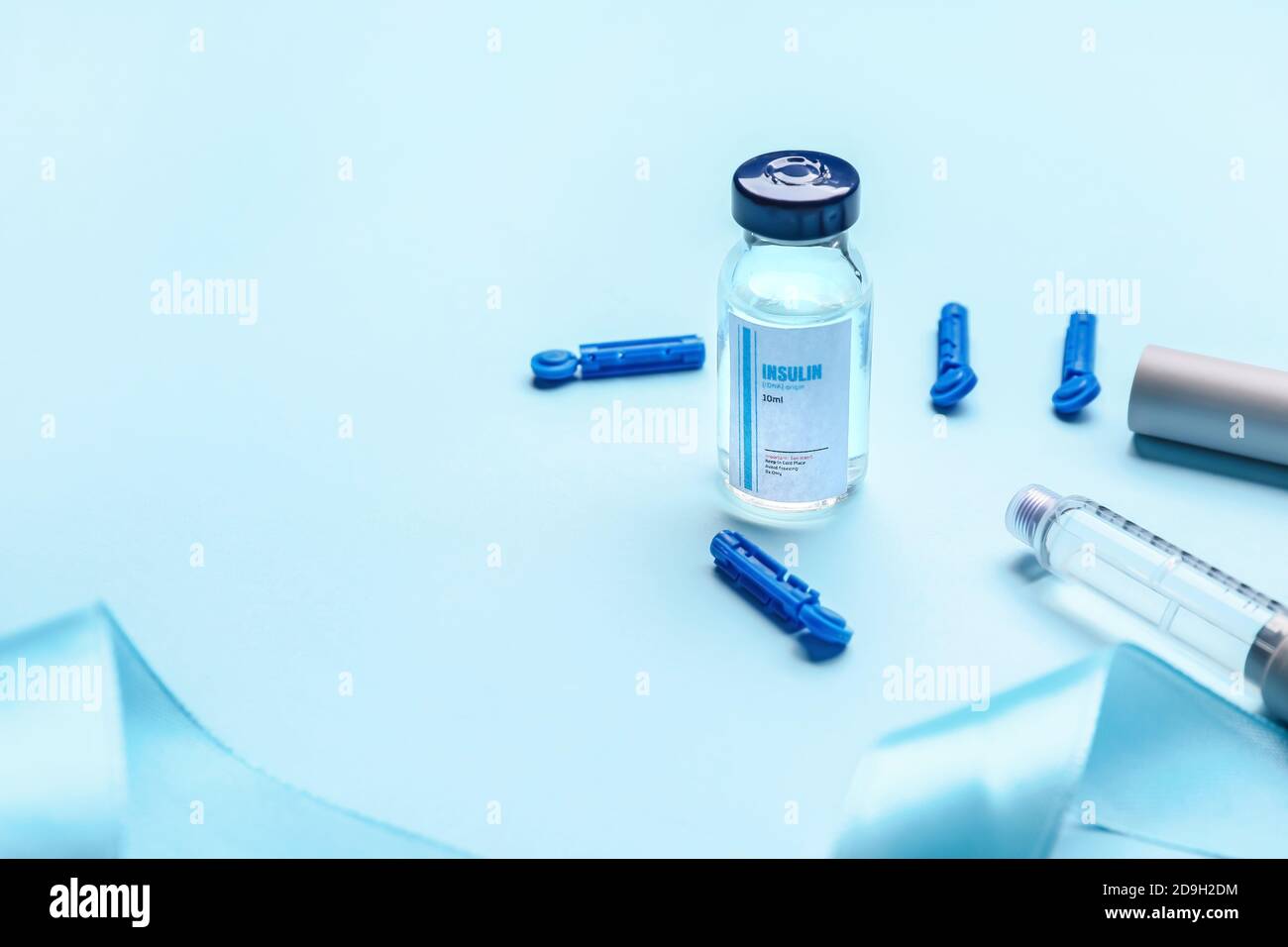 Bottle of insulin and syringe on color background. Diabetes concept ...