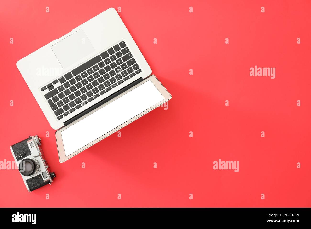 Modern laptop with photo camera on color background Stock Photo - Alamy