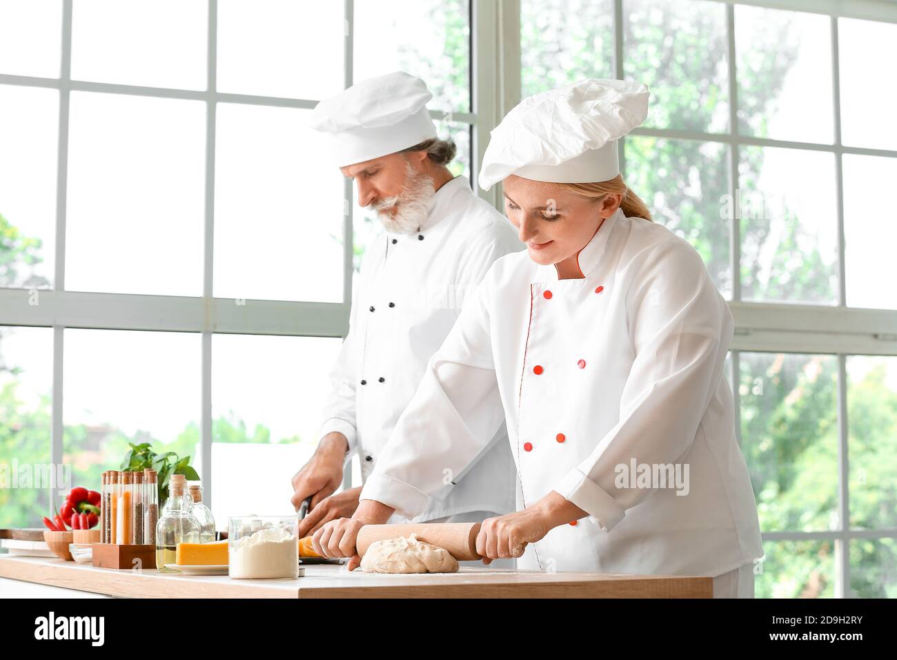 Mature chefs cooking in kitchen Stock Photo - Alamy