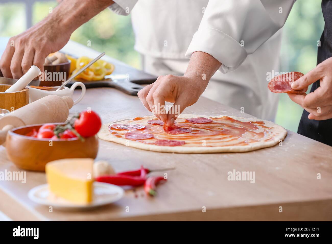 Male cooker making pizza hi-res stock photography and images - Alamy
