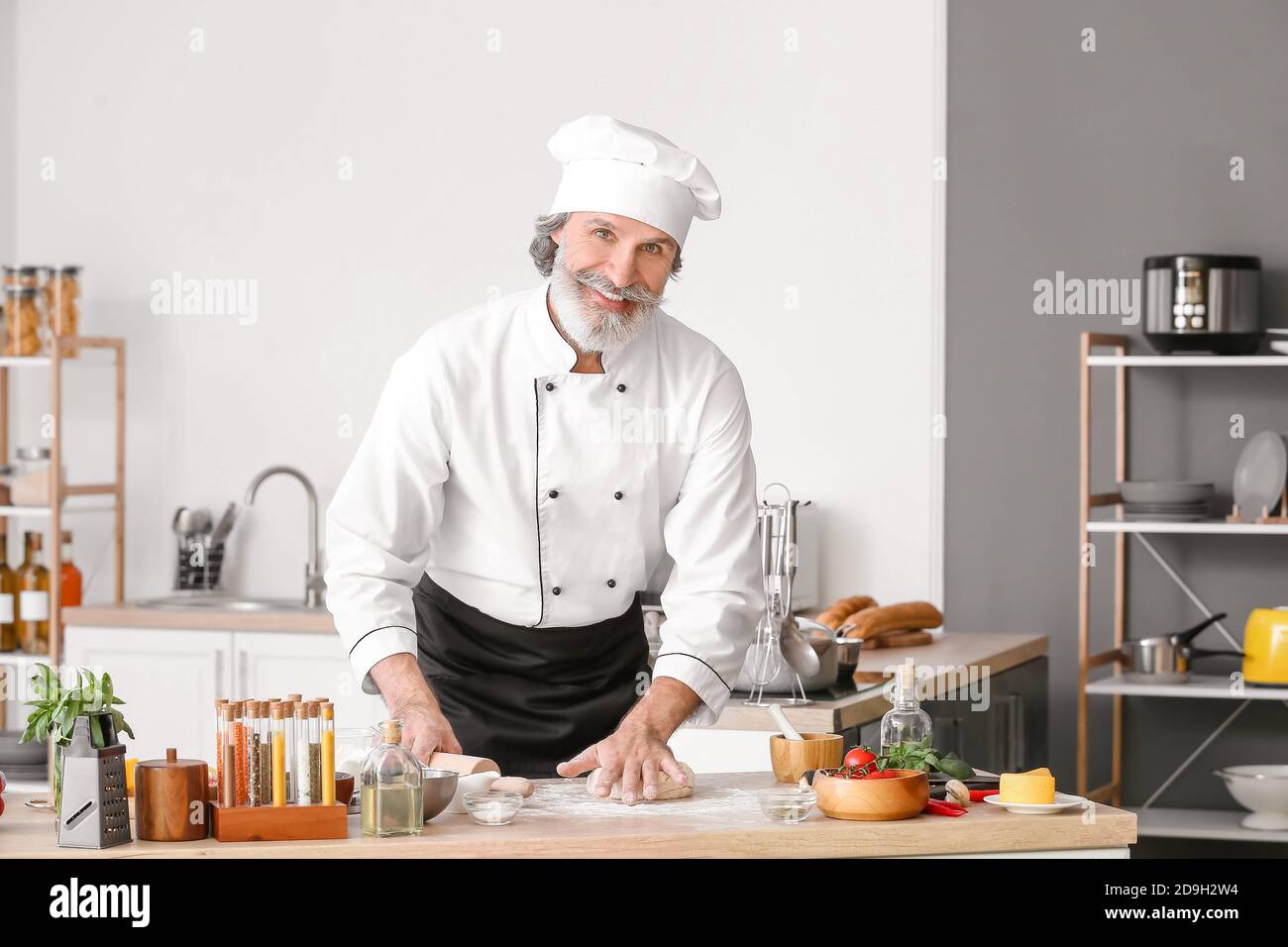 Mature male chef cooking in kitchen Stock Photo - Alamy