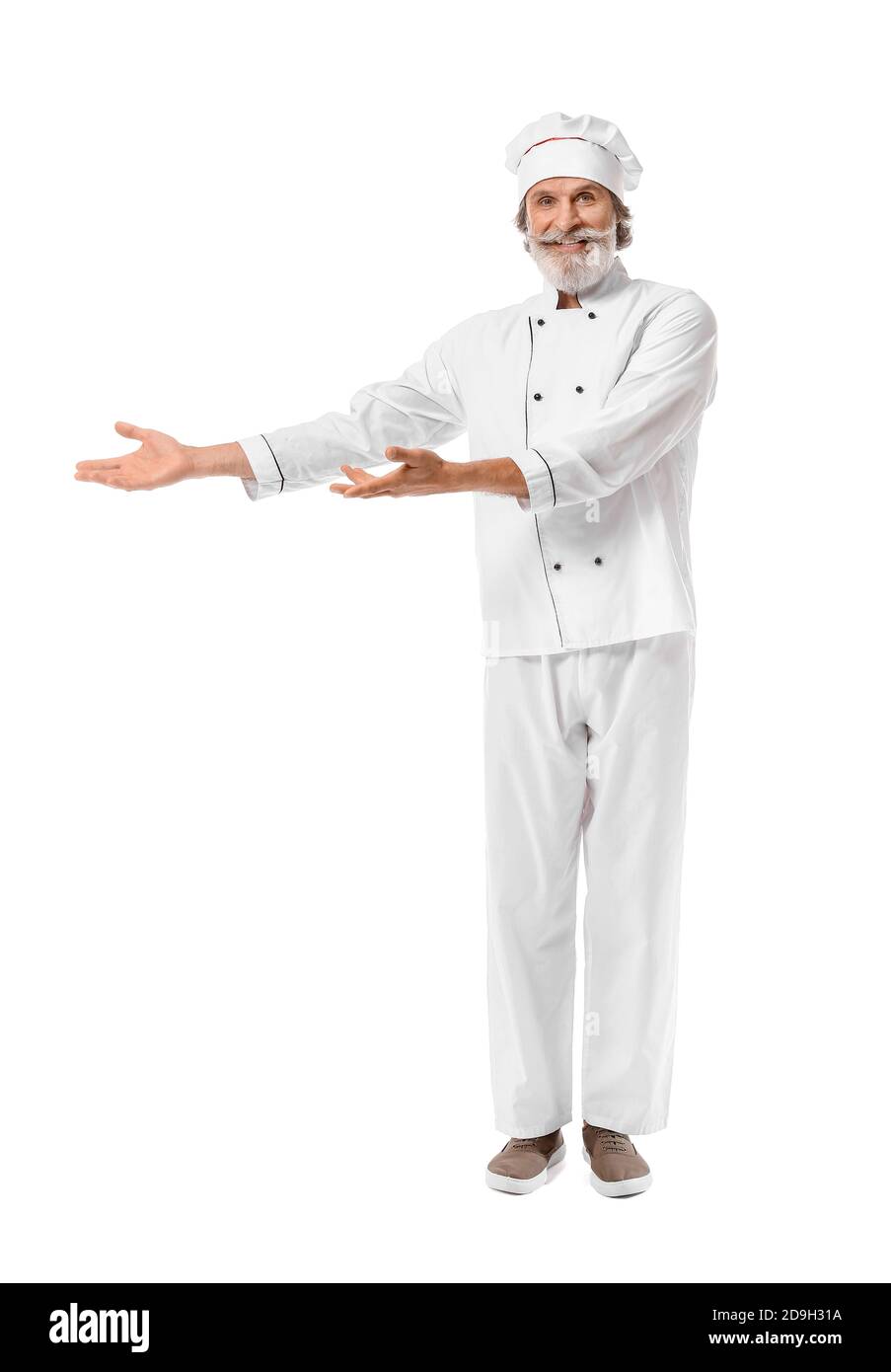 Mature male chef showing something on white background Stock Photo - Alamy