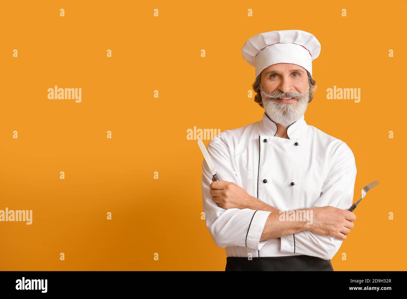 Mature male chef on color background Stock Photo - Alamy