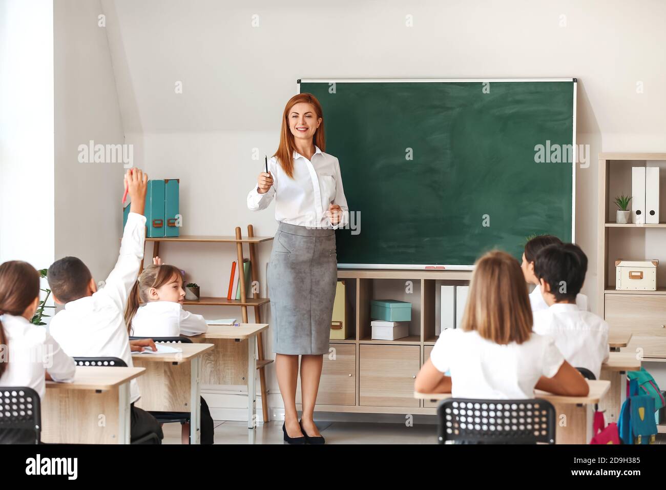 Teacher conducting lesson in classroom Stock Photo - Alamy