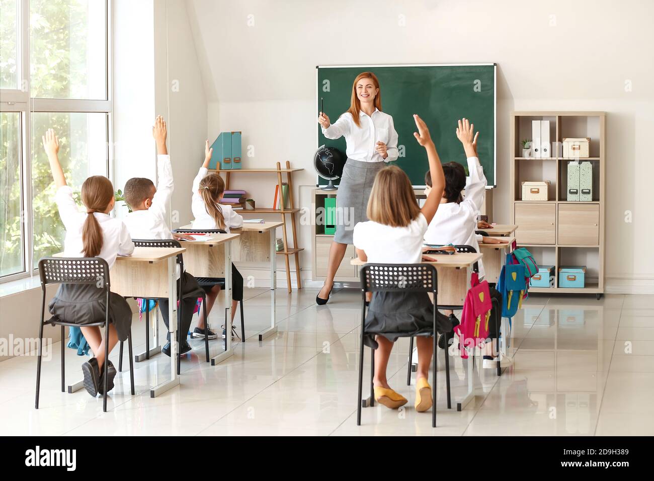 Teacher conducting lesson in classroom Stock Photo - Alamy
