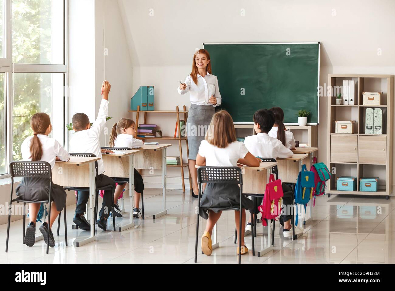 Teacher conducting lesson in classroom Stock Photo - Alamy