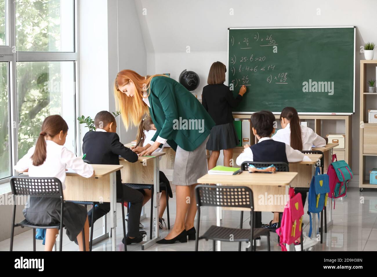 Teacher conducting lesson in classroom Stock Photo - Alamy