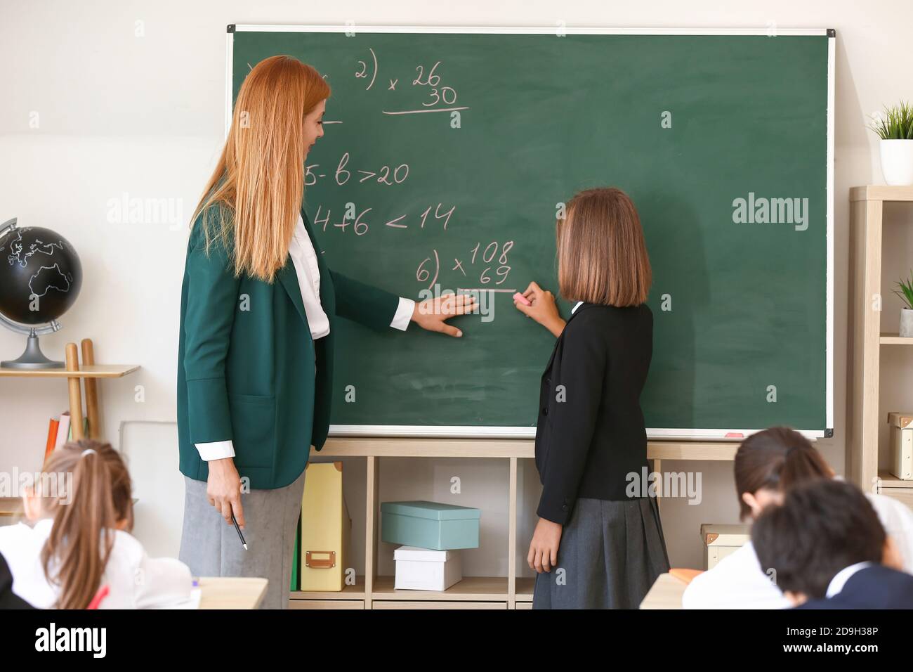 Teacher conducting lesson in classroom Stock Photo - Alamy