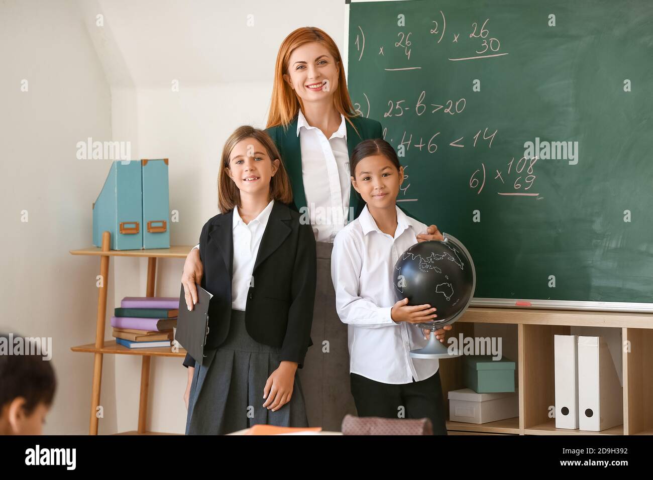 Children with teacher in classroom Stock Photo - Alamy