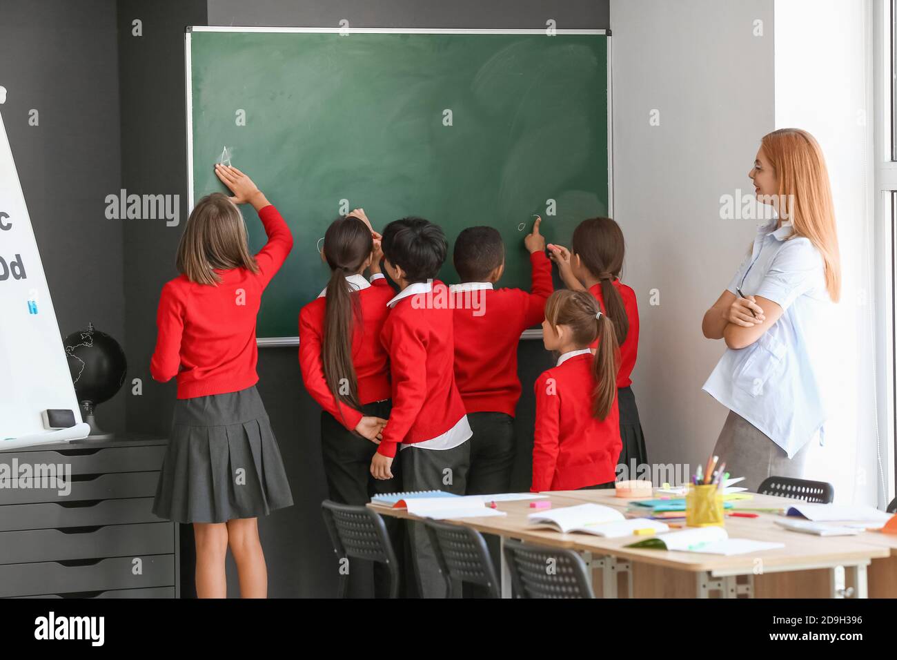 Teacher conducting lesson in classroom Stock Photo - Alamy