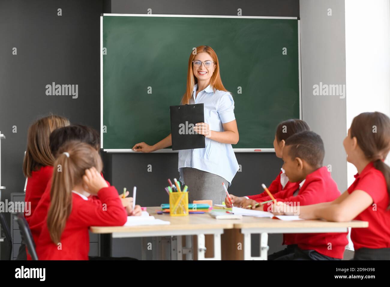 Teacher conducting lesson in classroom Stock Photo - Alamy