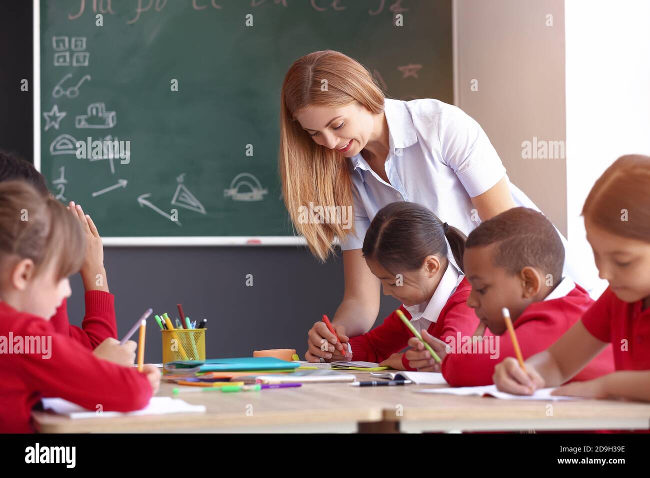 Teacher conducting lesson in classroom Stock Photo - Alamy