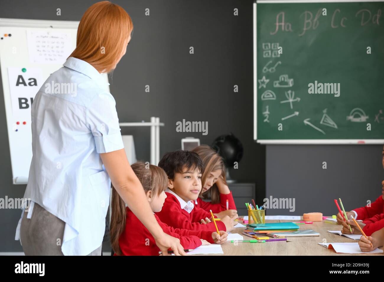 Teacher conducting lesson in classroom Stock Photo - Alamy