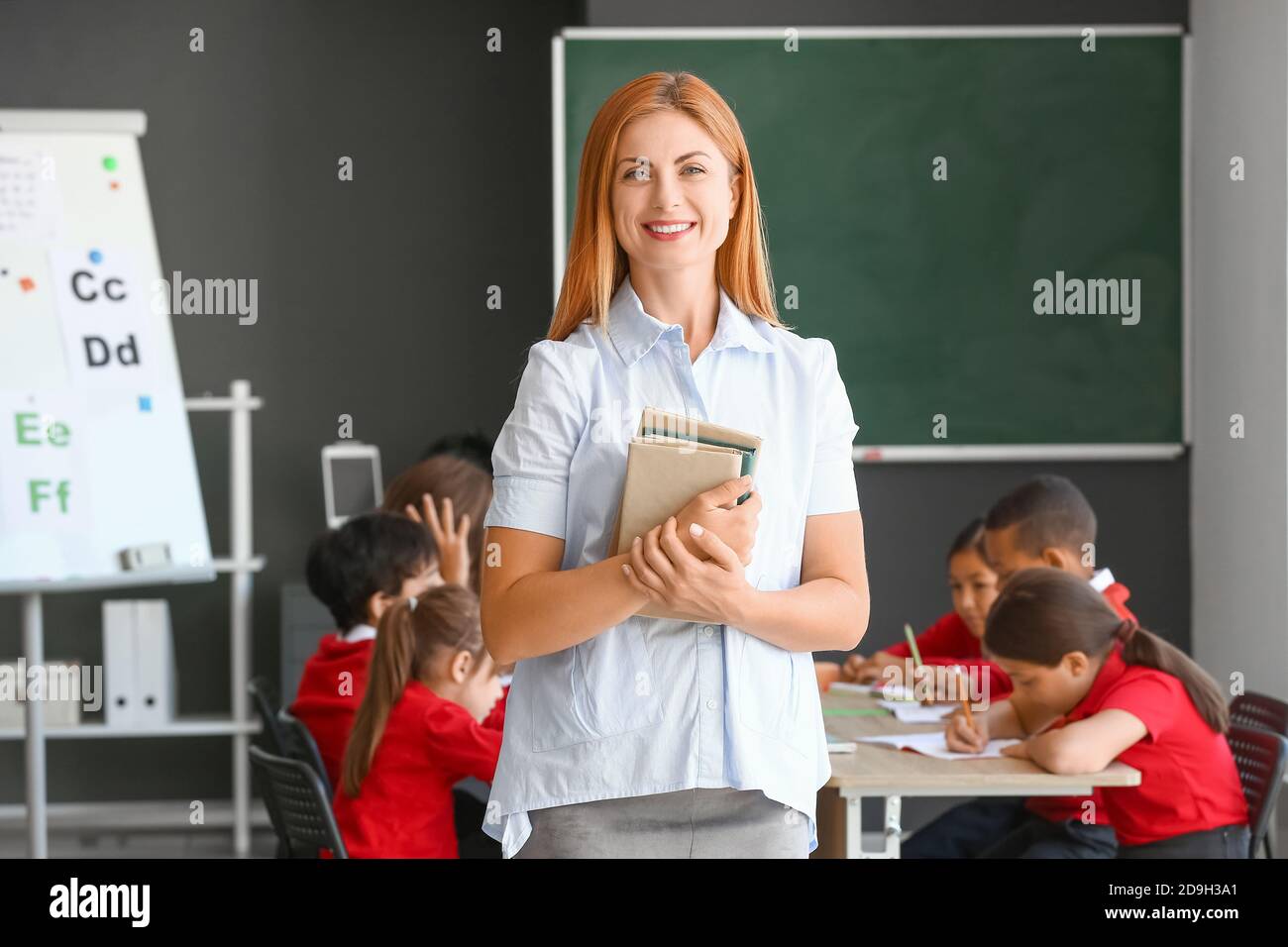 Portrait of beautiful teacher in classroom Stock Photo - Alamy